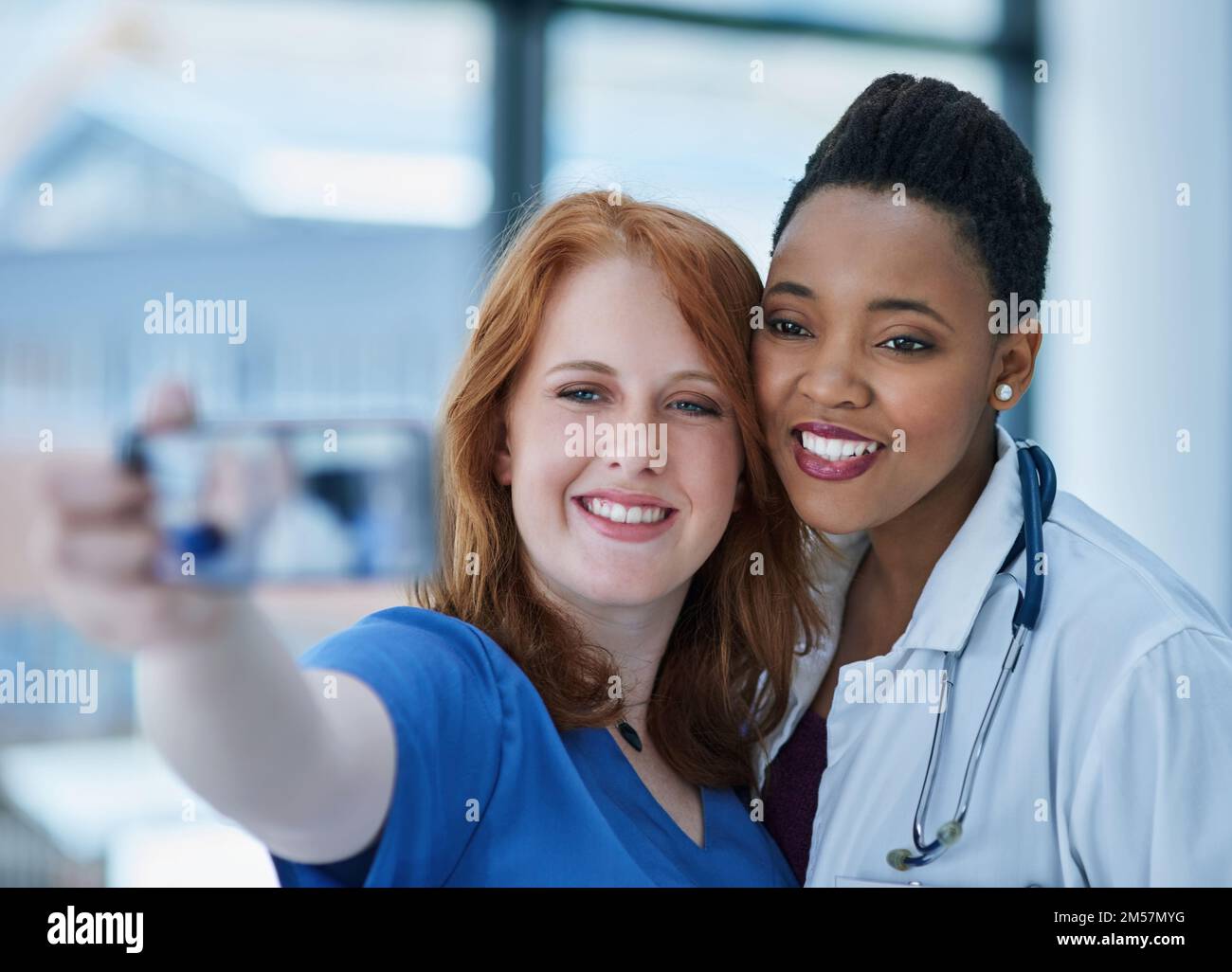 Millenials in the medical field. two young doctors taking a selfie ...