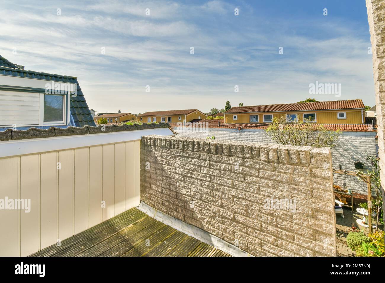 an outside area with some houses in the background and a blue sky above ...