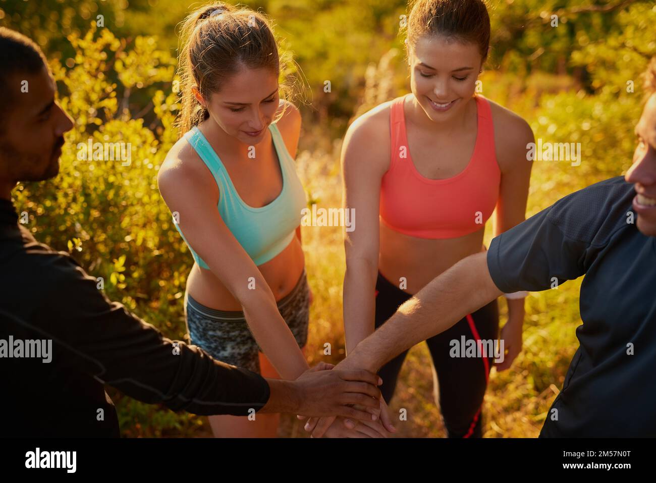 Together well achieve our fitness goals. a fitness group joining their ...