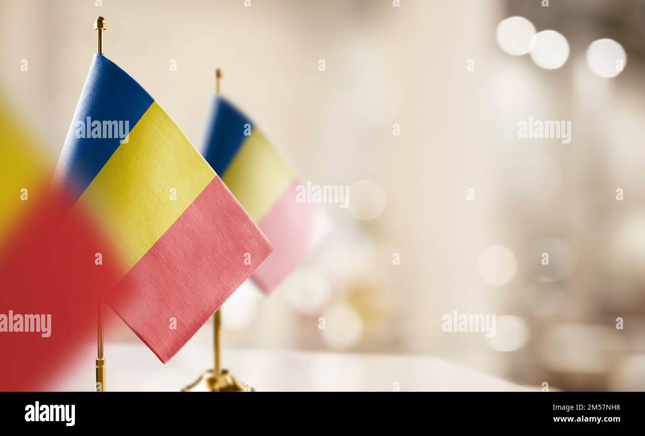 Small flags of the Romania on an abstract blurry background Stock Photo ...