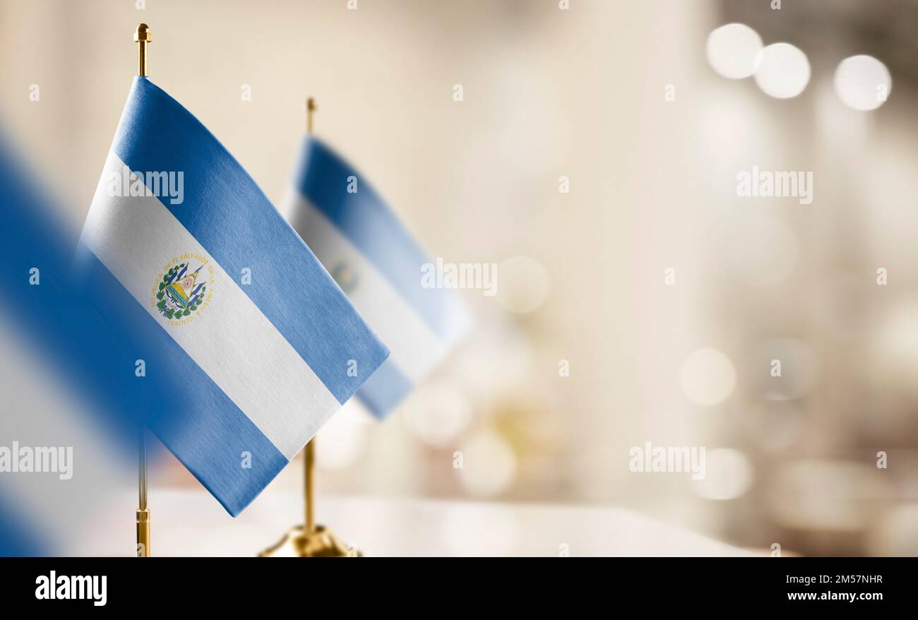 Small flags of the Salvador on an abstract blurry background Stock ...