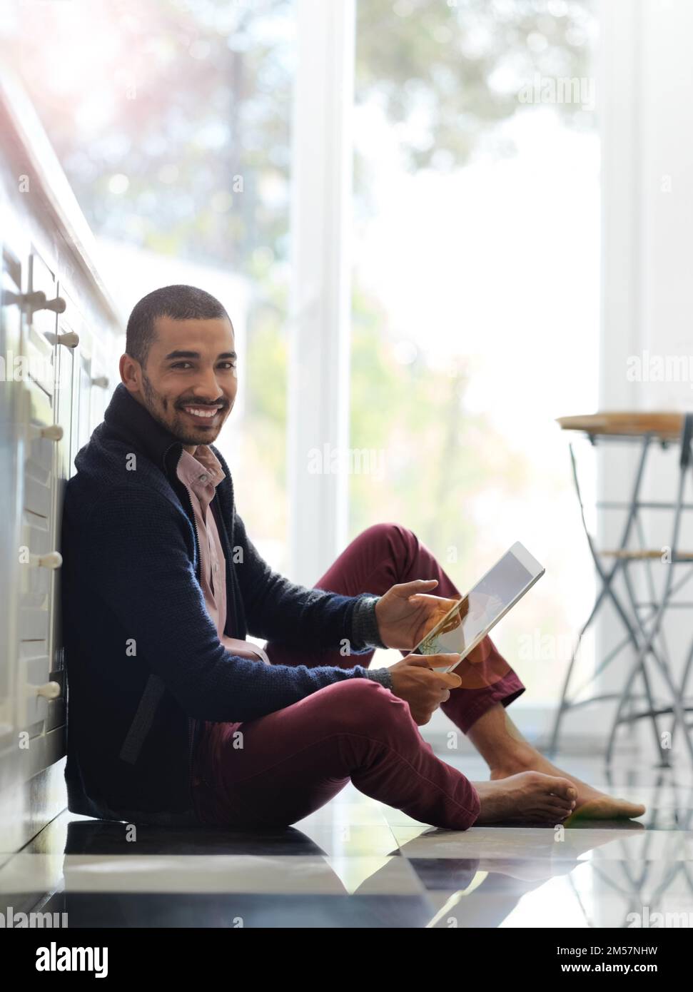 Getting work done from the comfort of the kitchen. Portrait of a ...