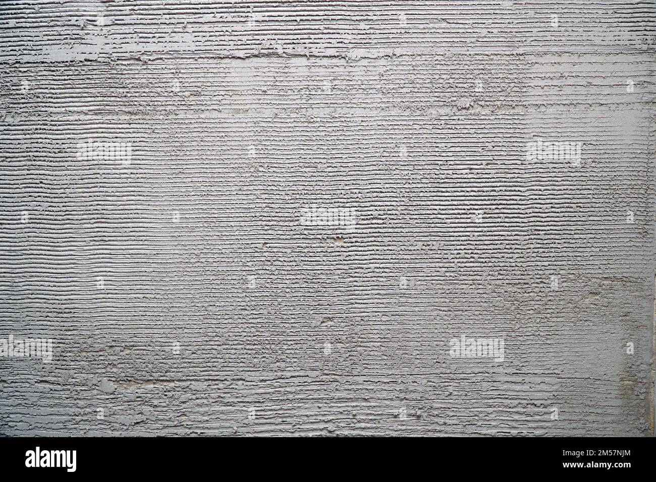 Gray decorative plaster on the wall with pressed horizontal stripes ...