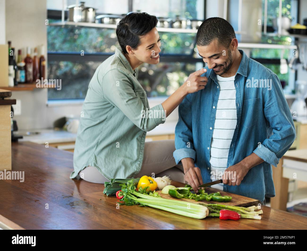 Youre the cutest chef Ive ever seen. a smiling young couple preparing a ...