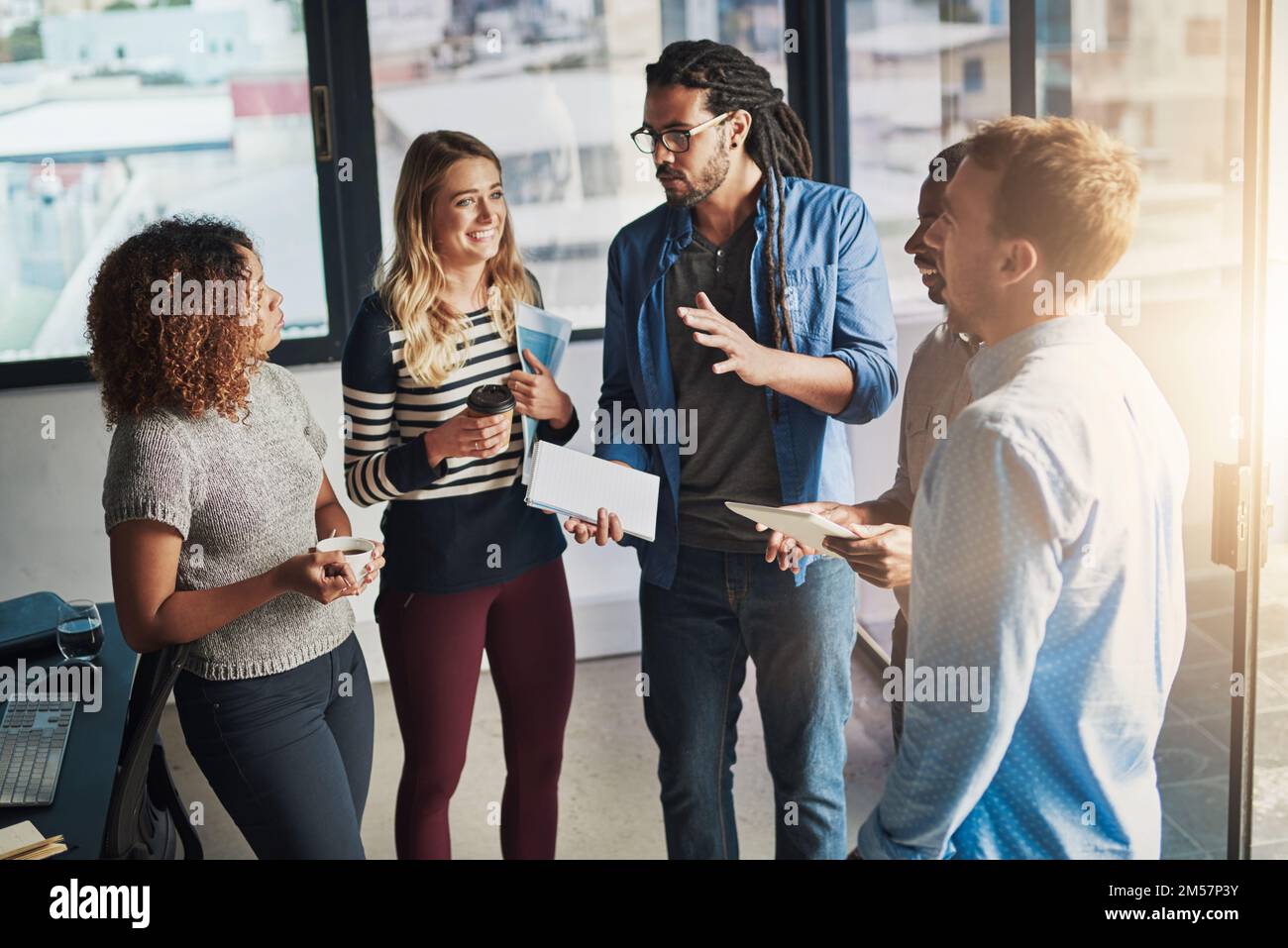 Lets talk this through. High angle shot of a group of young designers ...