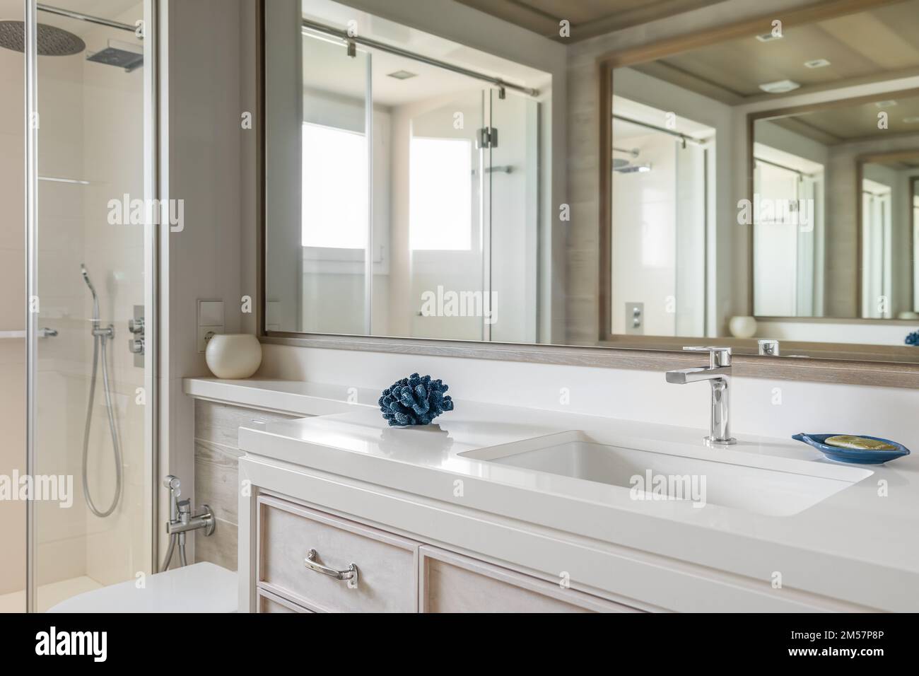 Luxurious bathroom with a large mirror with an unusual multiple ...