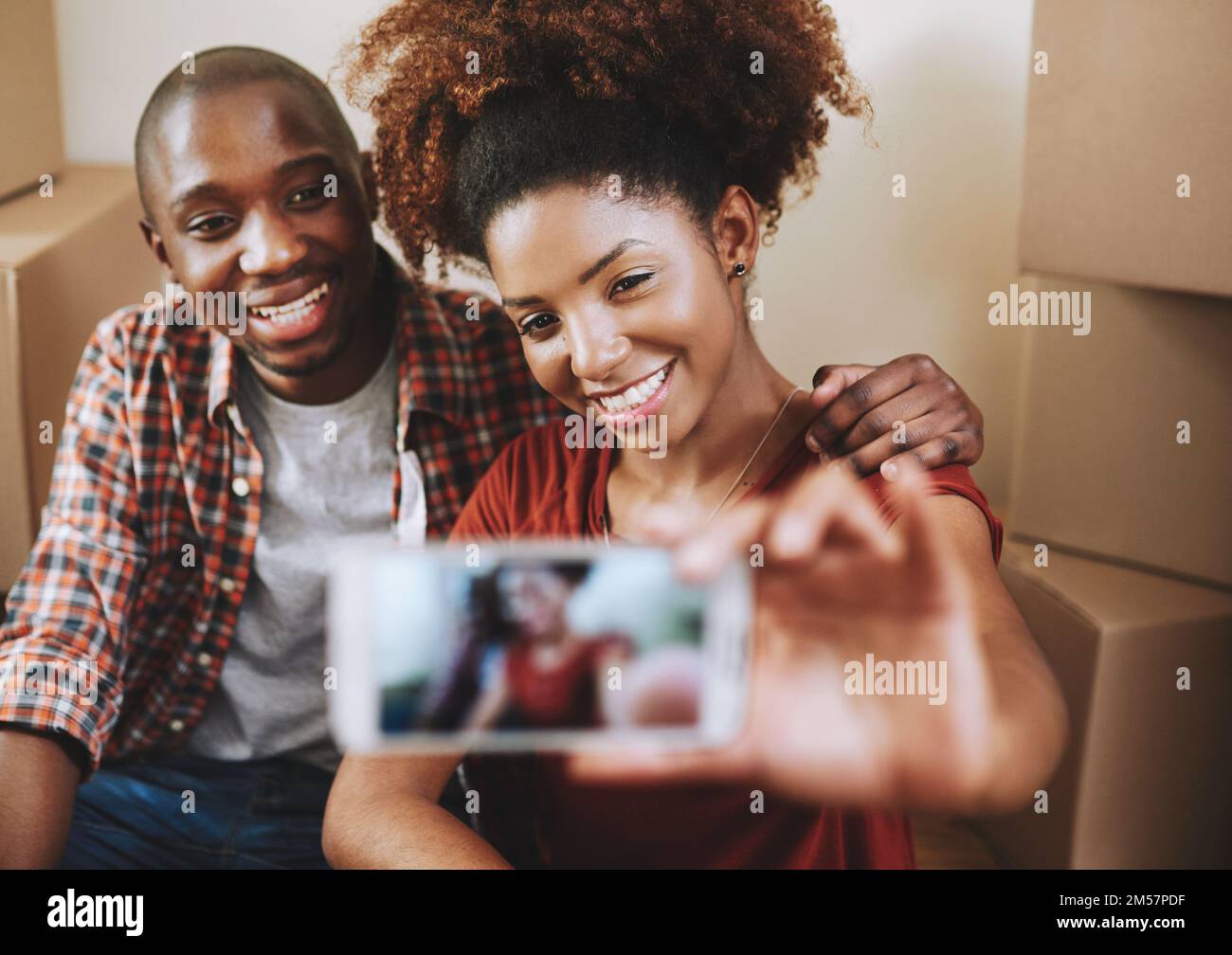 We finally moved in together. a young couple taking a selfie in their ...