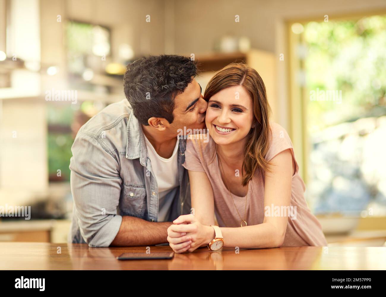 She considers herself very lucky. an affectionate young man kissing his ... She considers herself very lucky. an affectionate young man kissing his ...