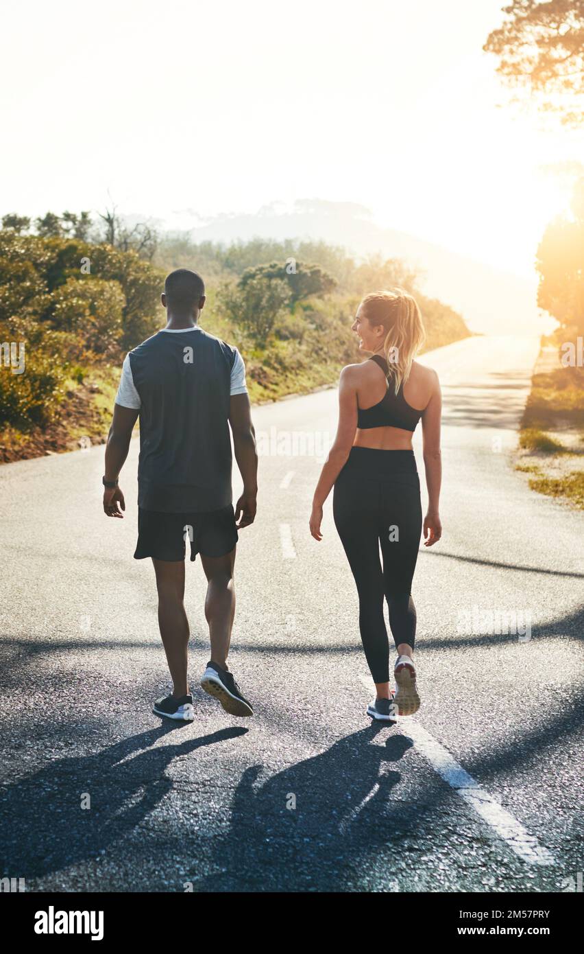 Having their workout in natures gym. a fit young couple slowing down ...