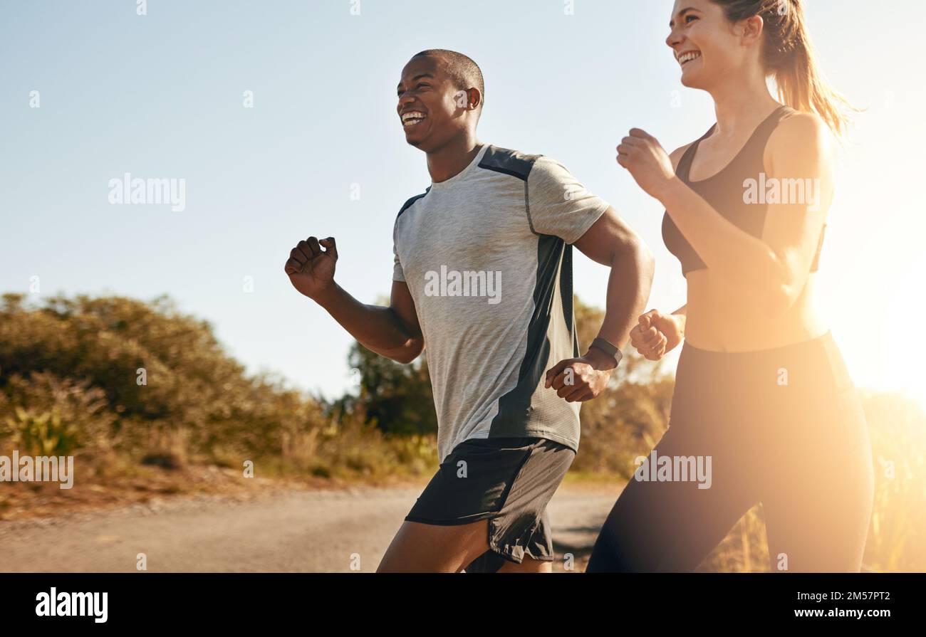 Every mile is worth your while. a fit young couple going for a run ...