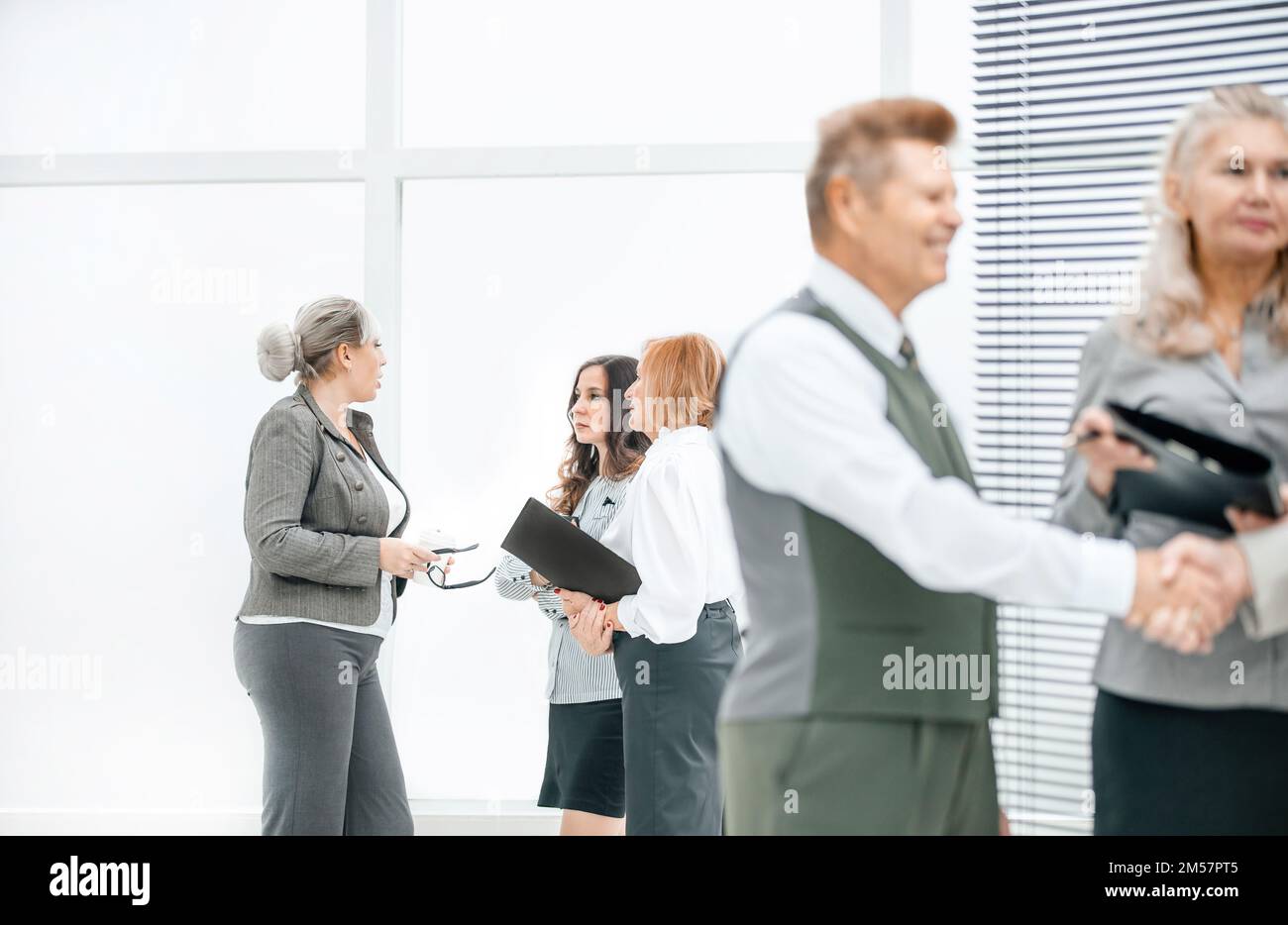 close up. company employees standing in the office lobby Stock Photo ...
