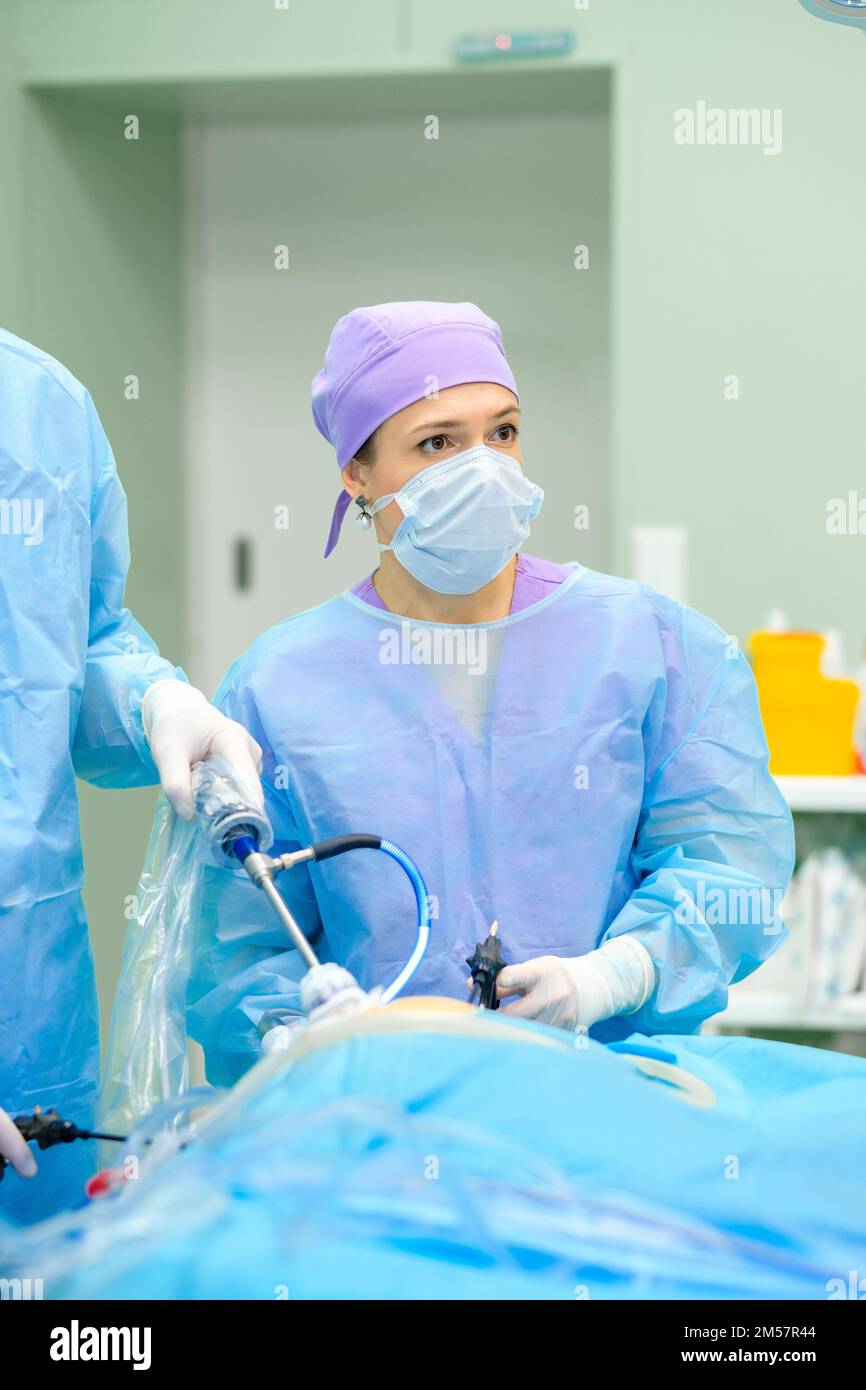 Focused look of female surgeon during laparoscopic surgery. A female ...