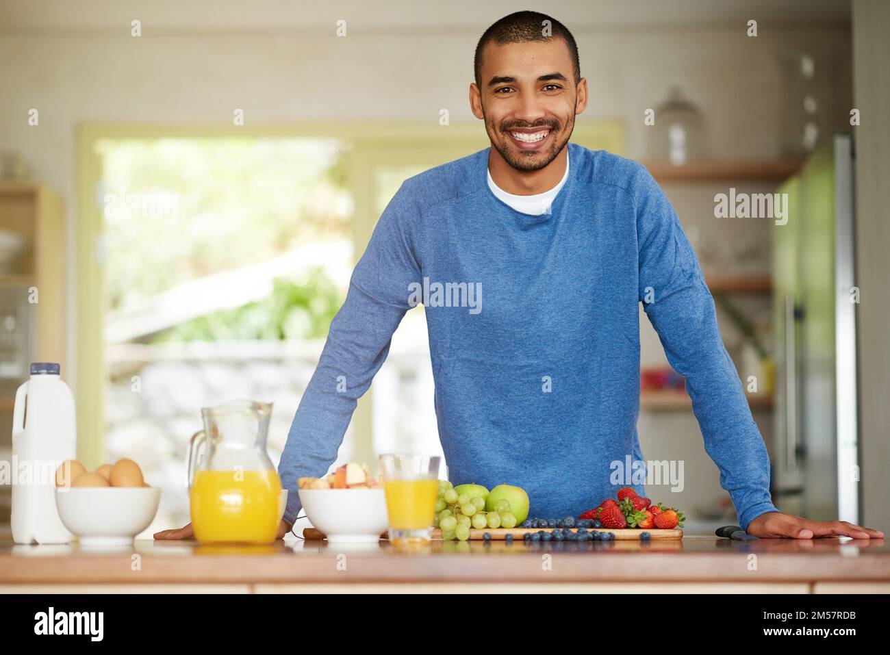 Food is life. Make it good. Portrait of a happy young man preparing a ...