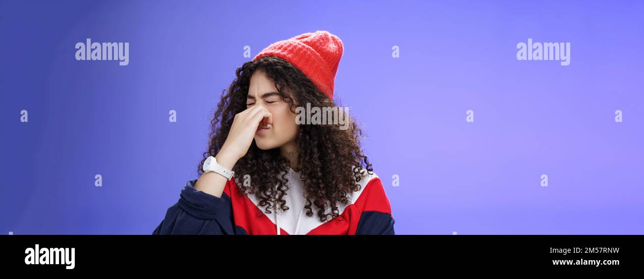 Gosh what nasty reek. Potrait of displeased and disgusted woman wanna ...