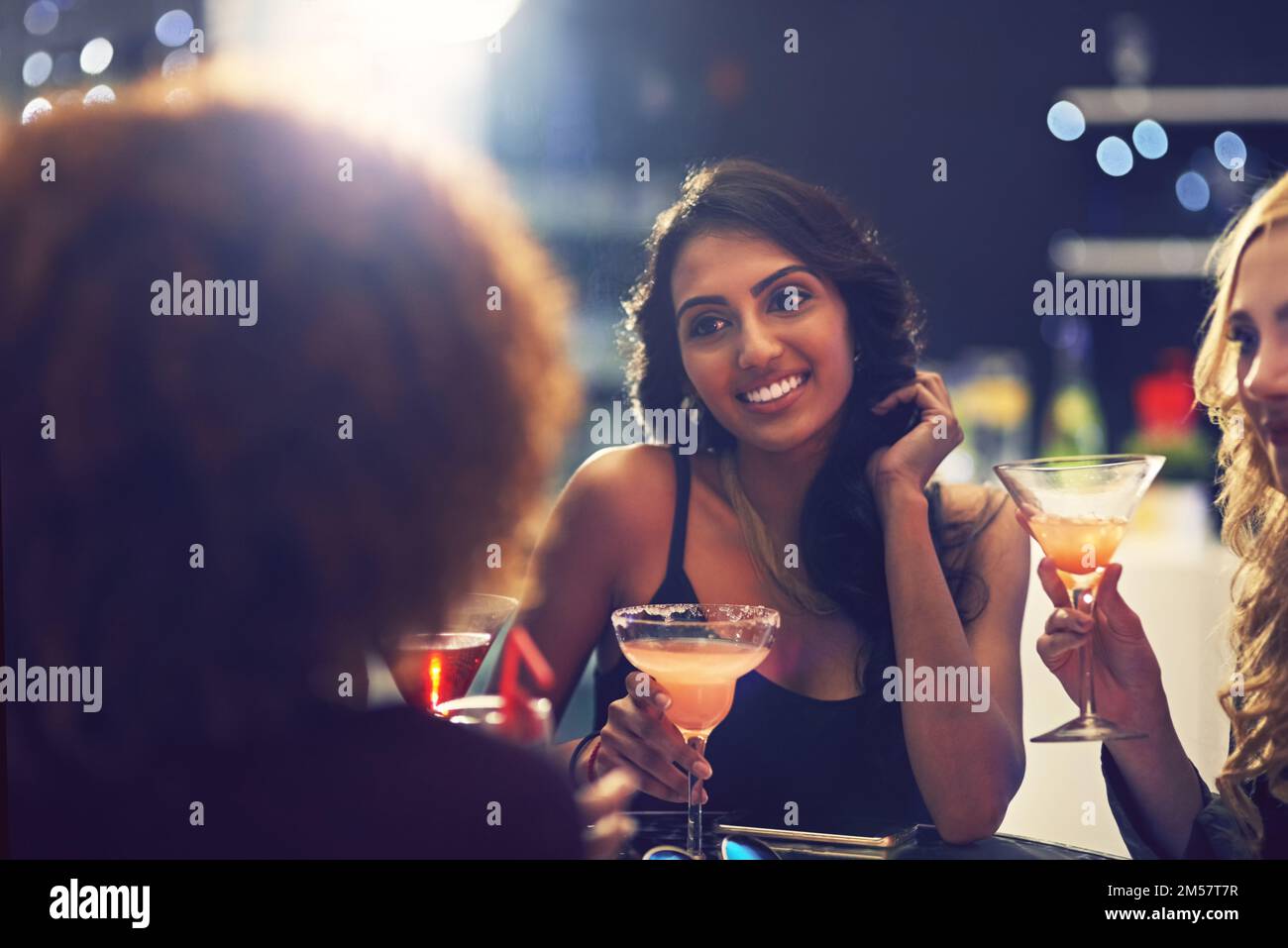 Starting the night off right. a group of friends relaxing with ...