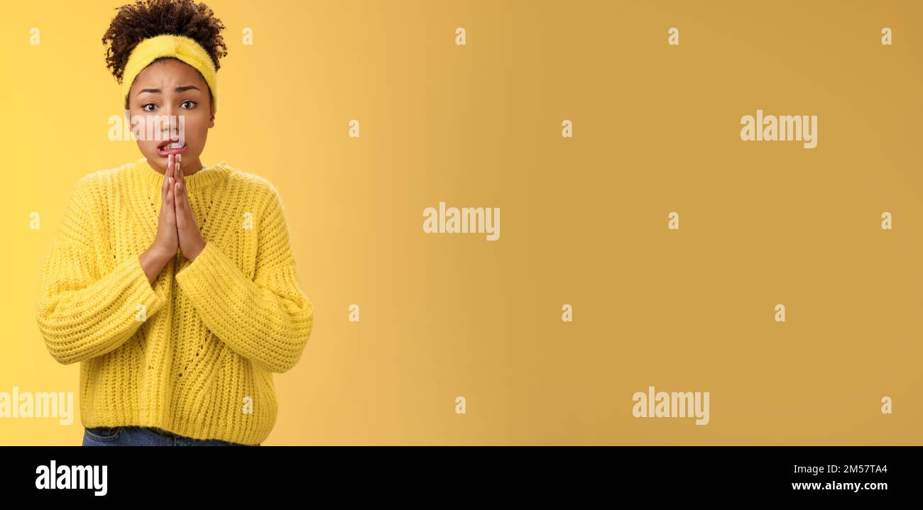 Intense worried perplexed young gloomy african-american woman hold ...