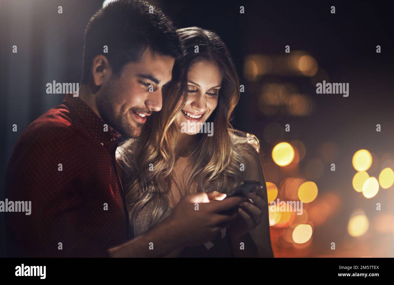 Lets exchange numbers. a young couple using their smartphones together ...