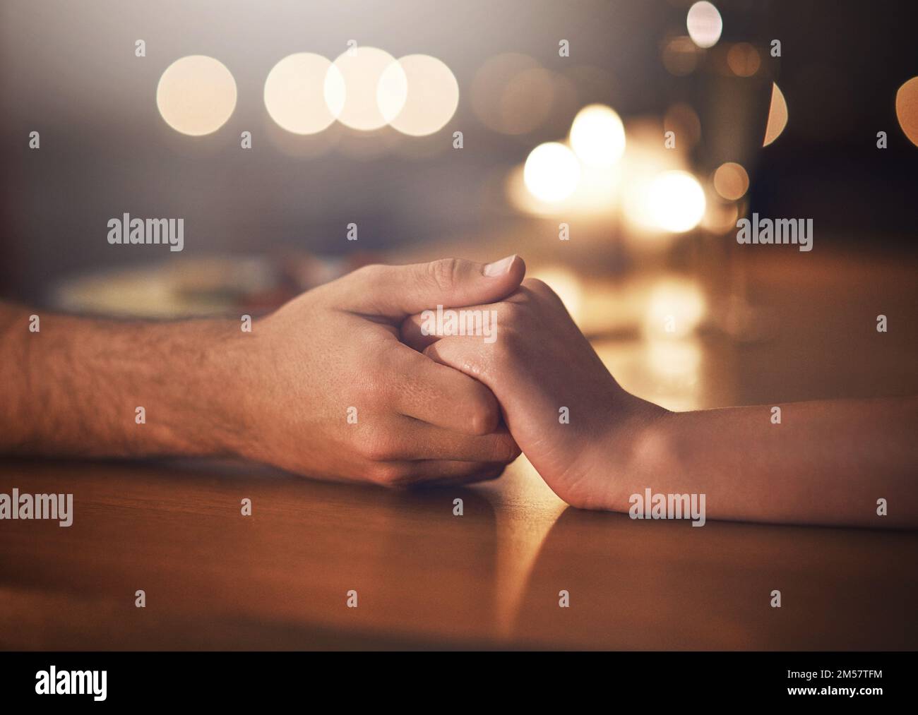 Let me lend a hand. a couple holding hands against a night time ...