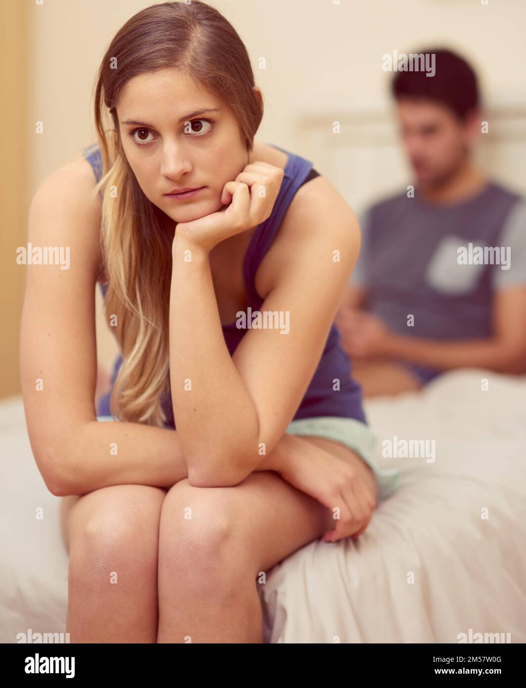 Trouble Brewing In Paradise An Unhappy Young Woman Sitting On The Bed After Having A Fight With
