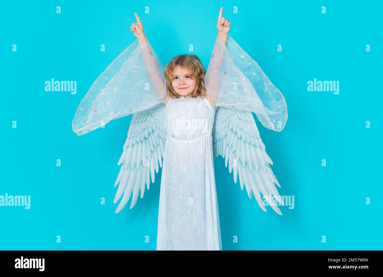 Kid wearing angel costume white dress and feather wings. Innocent child ...