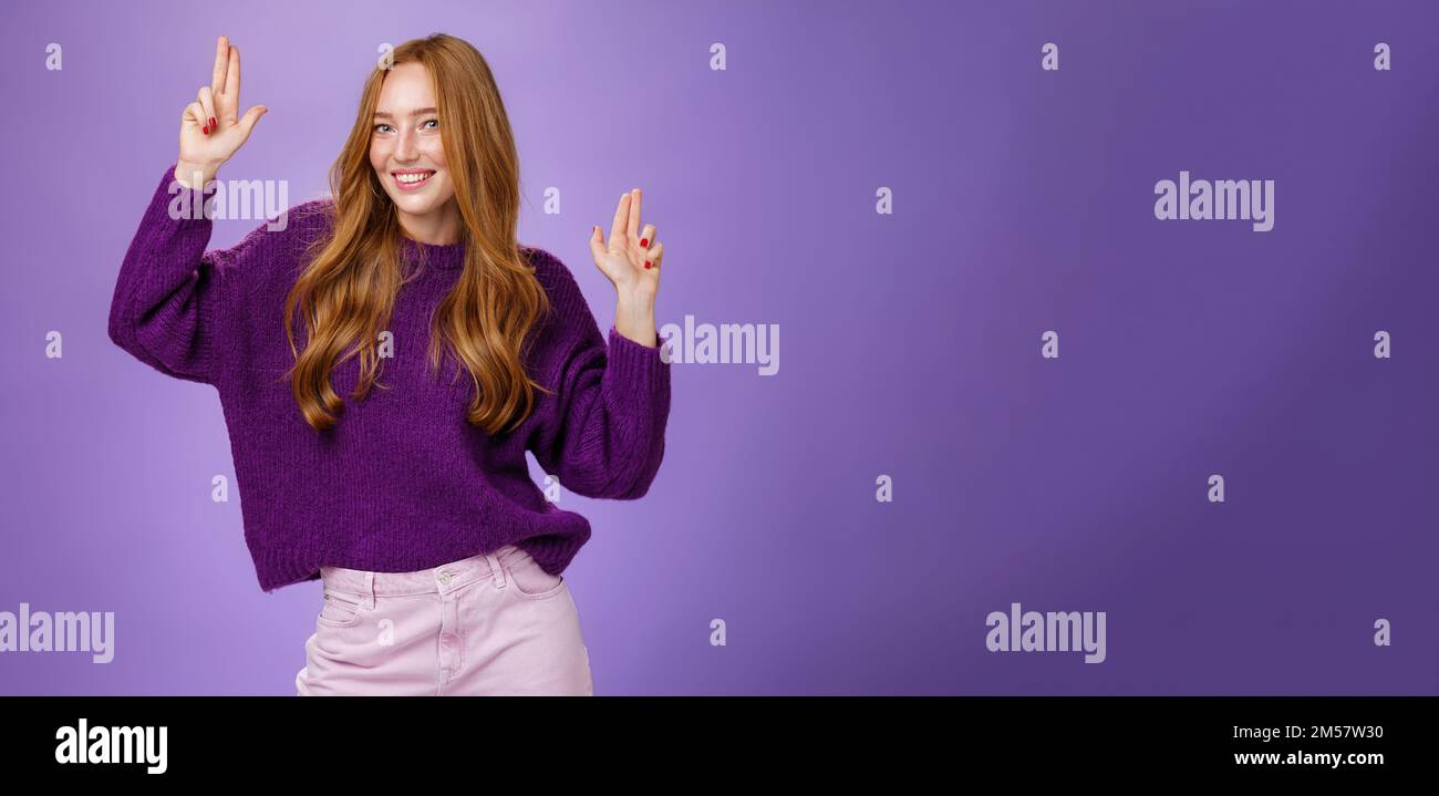 Girl in happy and energized mood dancing having fun making finger ...