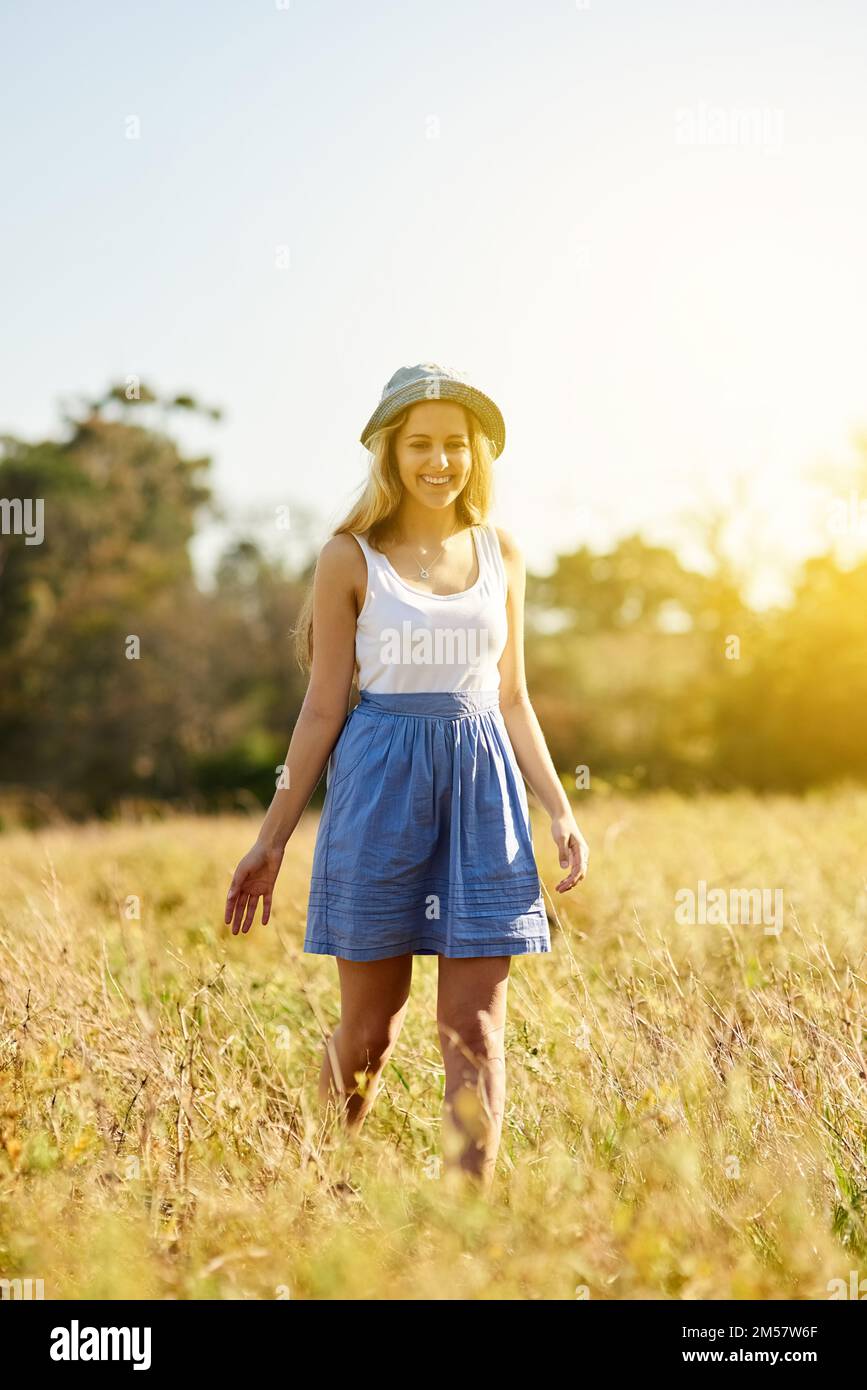 Spending time in nature boosts happiness. a young woman on a tree stump ...