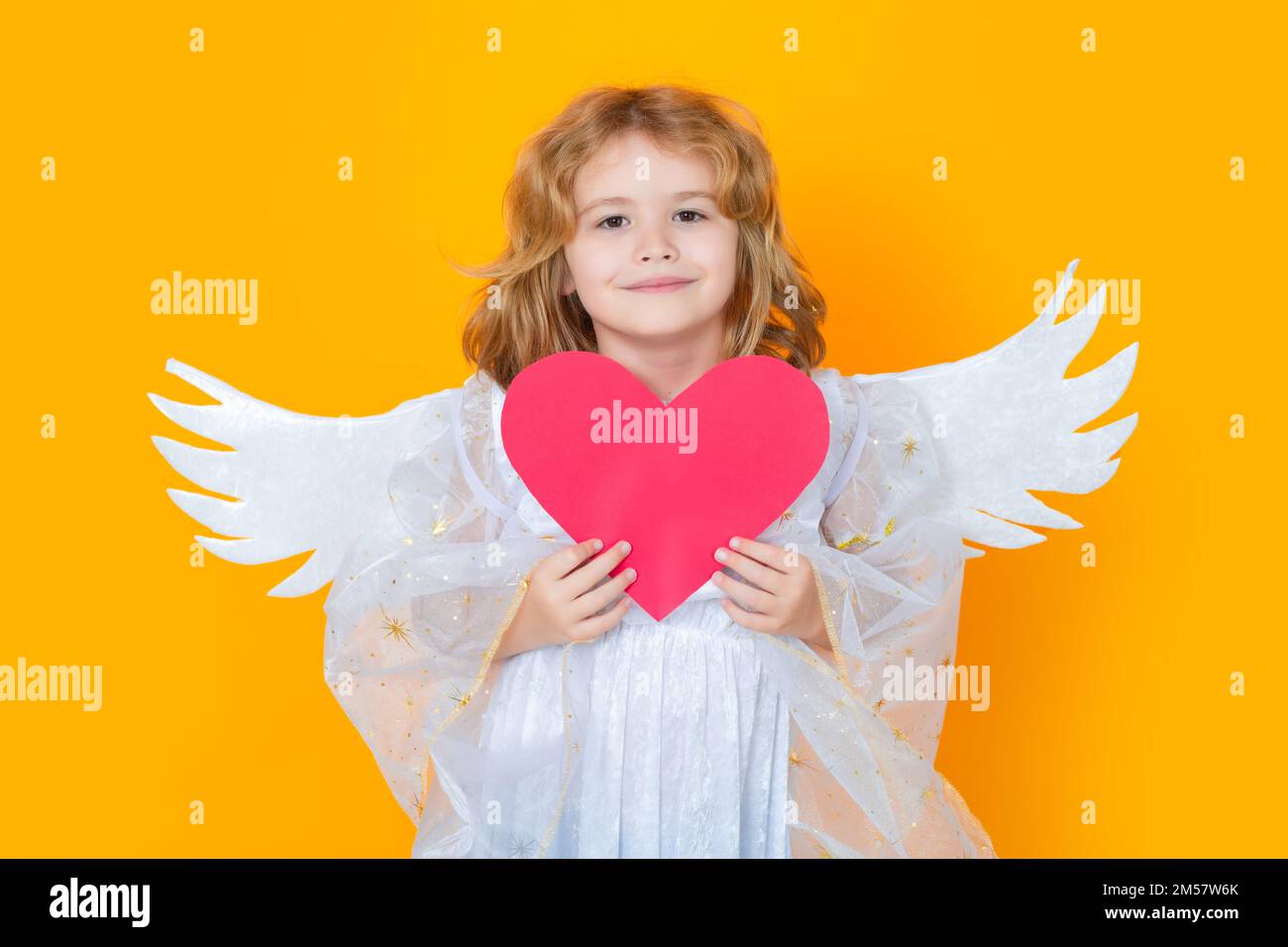 Angel child with heart. Cute angel child, studio portrait. Angel kid ...