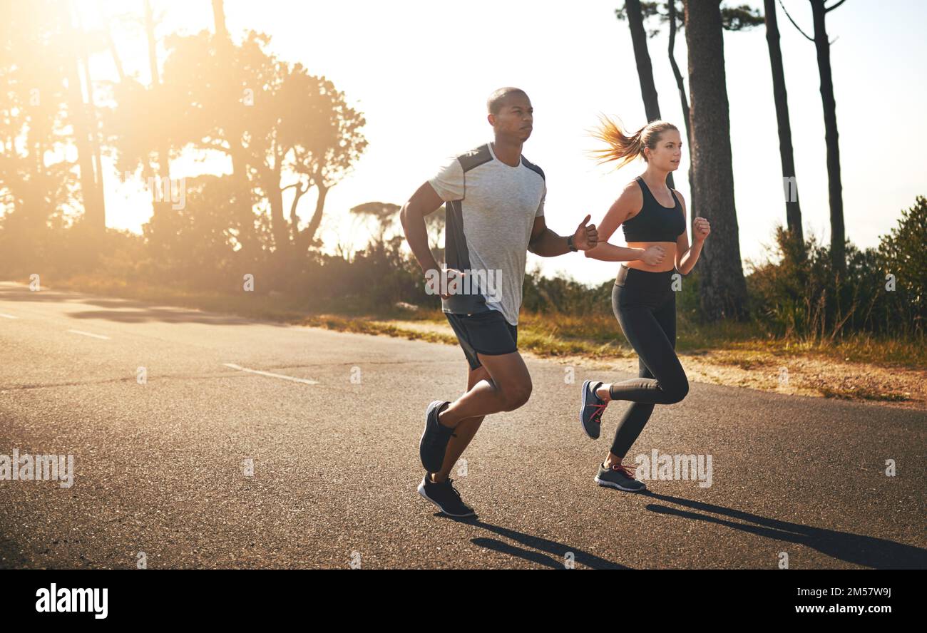 Each mile gets better and better. a fit young couple going for a run outdoors Stock Photo - Alamy