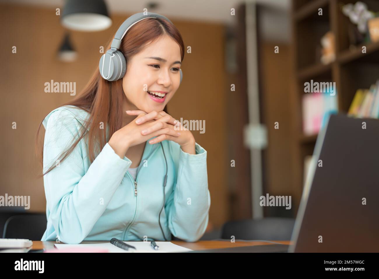 College education concept, Teenage girl wear headphone and watch video ...