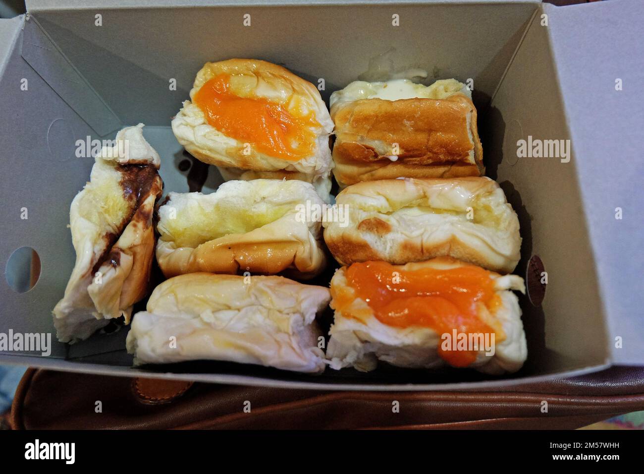 Close up paper box of Grilled bread toast filled with butter paste and ...