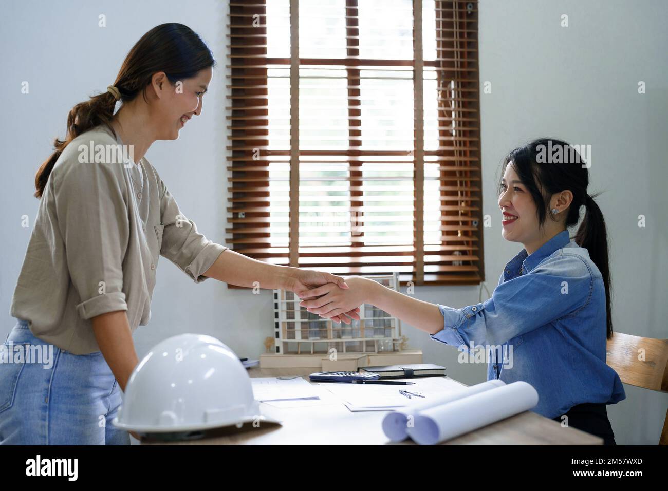 Engineering construction concept, Two female engineers shake hands ...