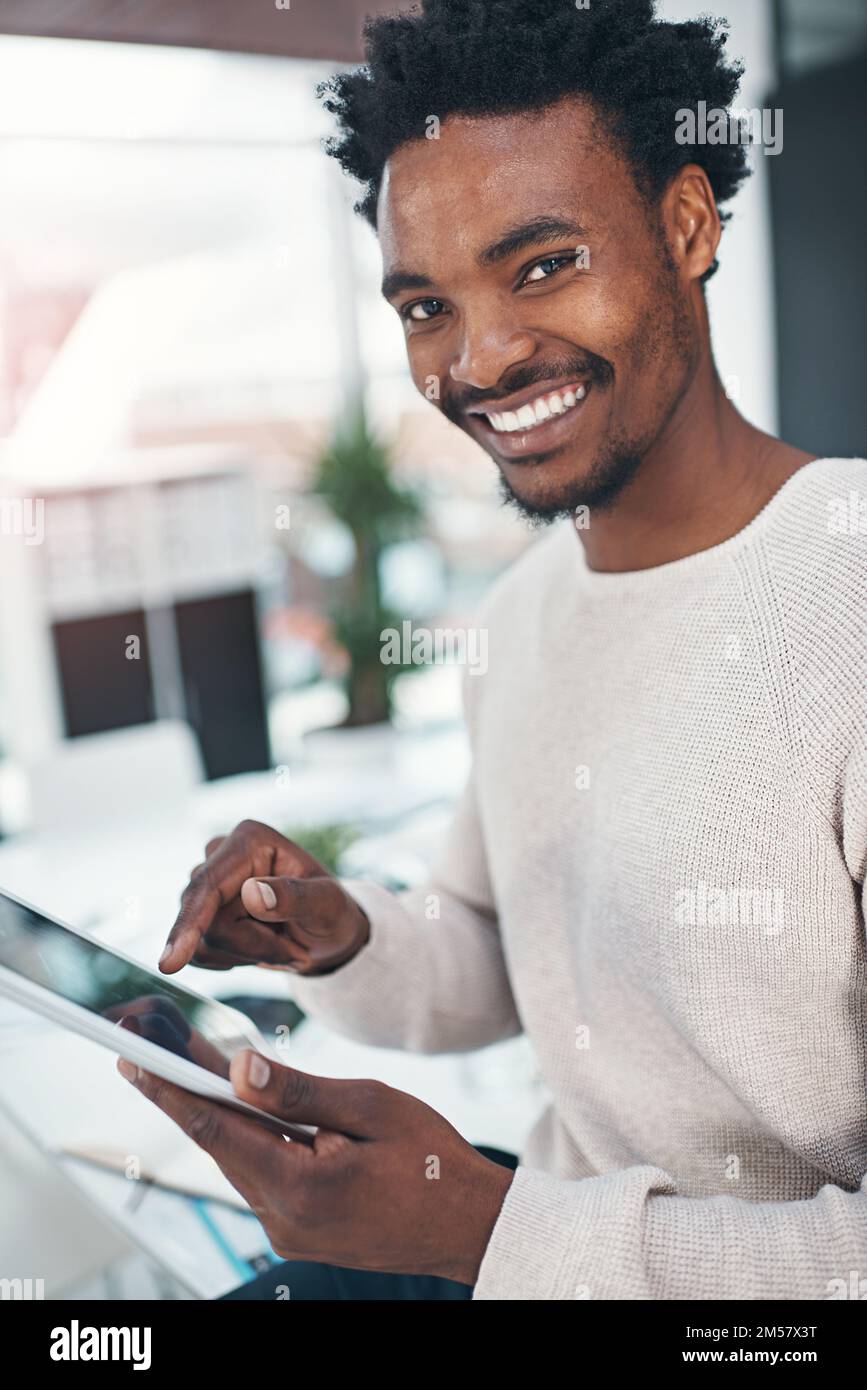 Its a tool for success. Portrait of a successful businessman using his ...