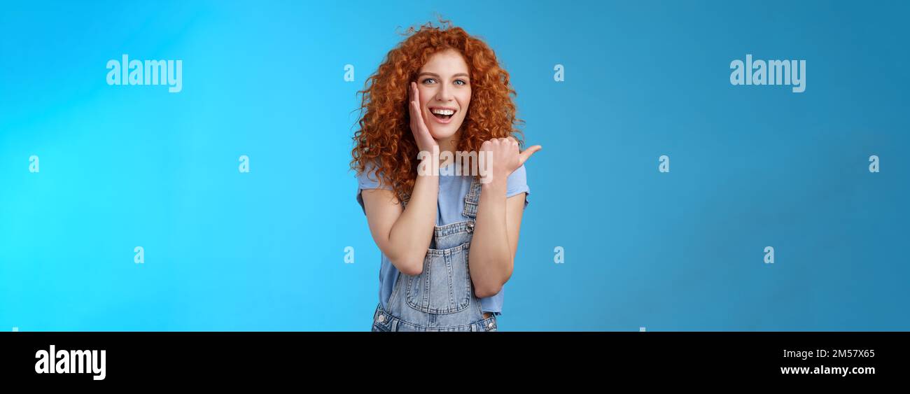Entertained charismatic good-looking ginger girl curly hairstyle touch ...