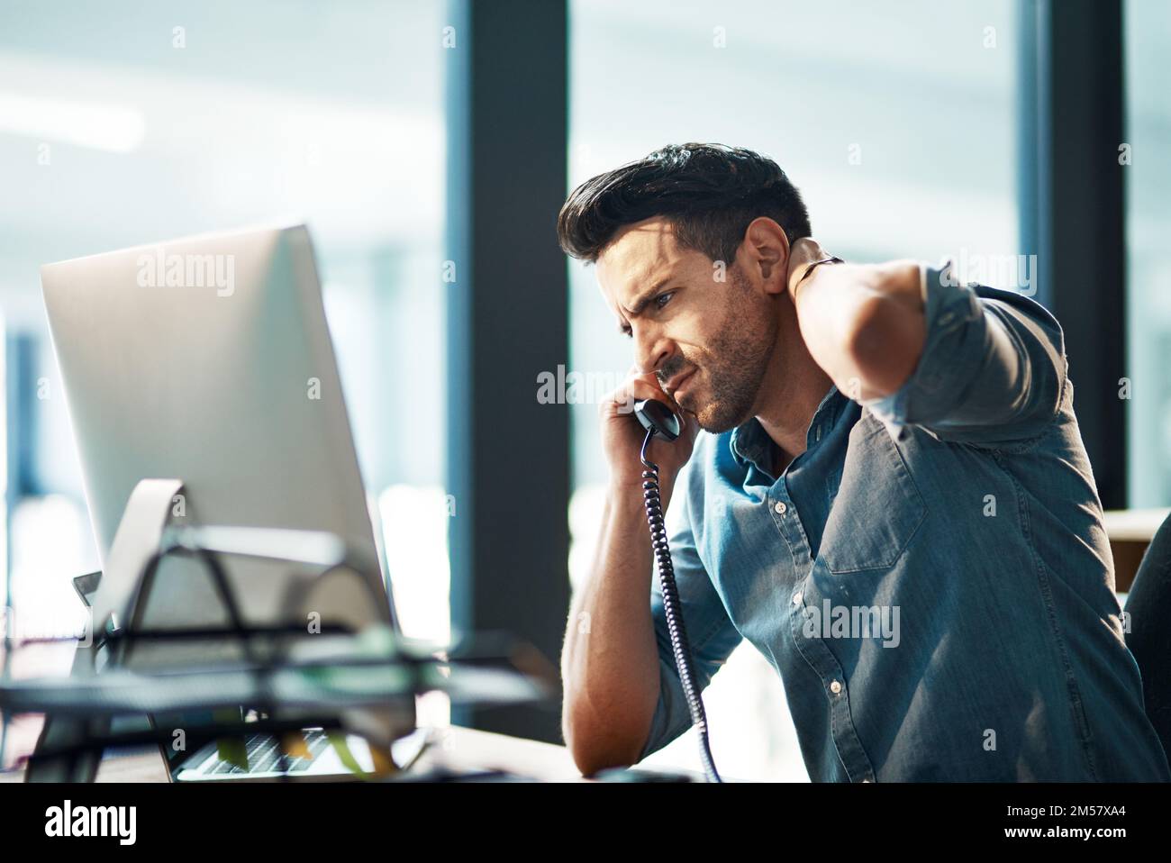 The call that no one likes to get. a young businessman looking stressed ...