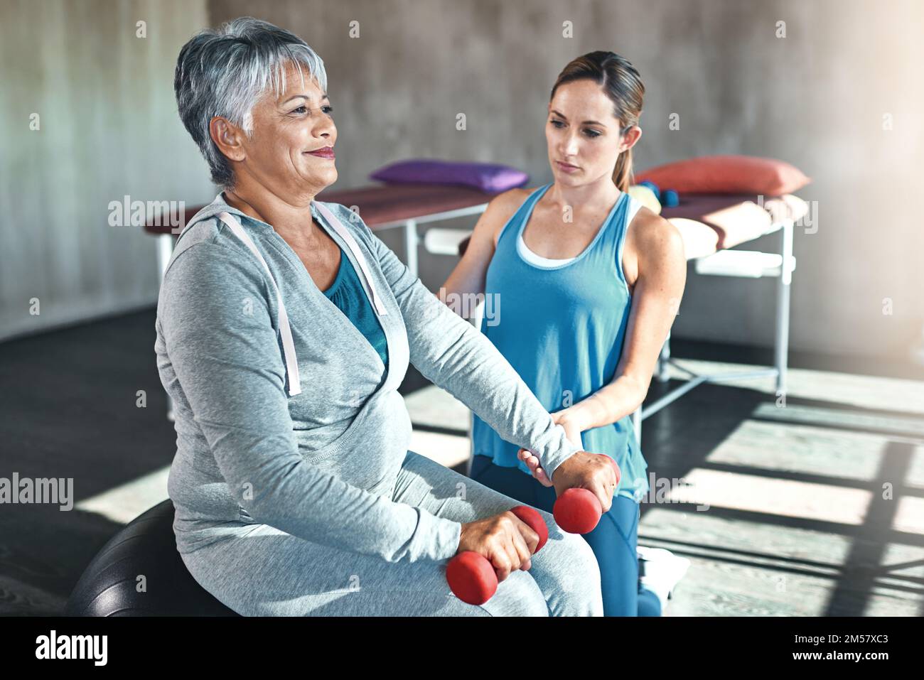 Working together to improve muscle strength and tone. a senior woman ...