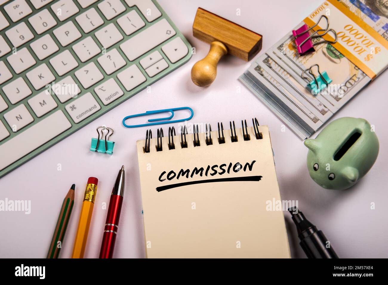 Commission concept. Money, computer keyboard and office supplies on ...