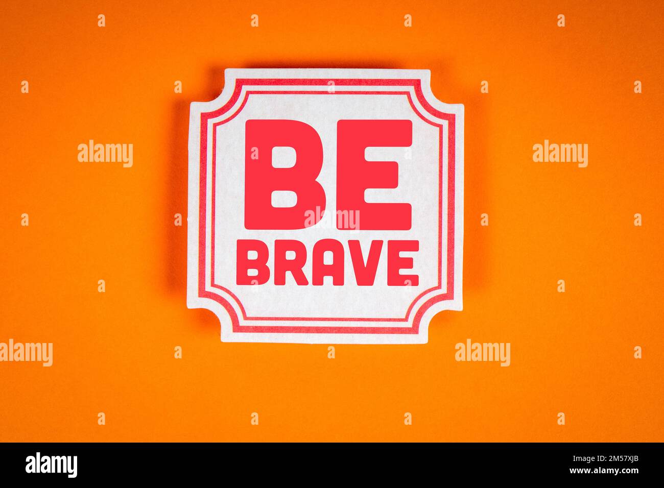 BE BRAVE. Sticky note with text on a orange background Stock Photo - Alamy