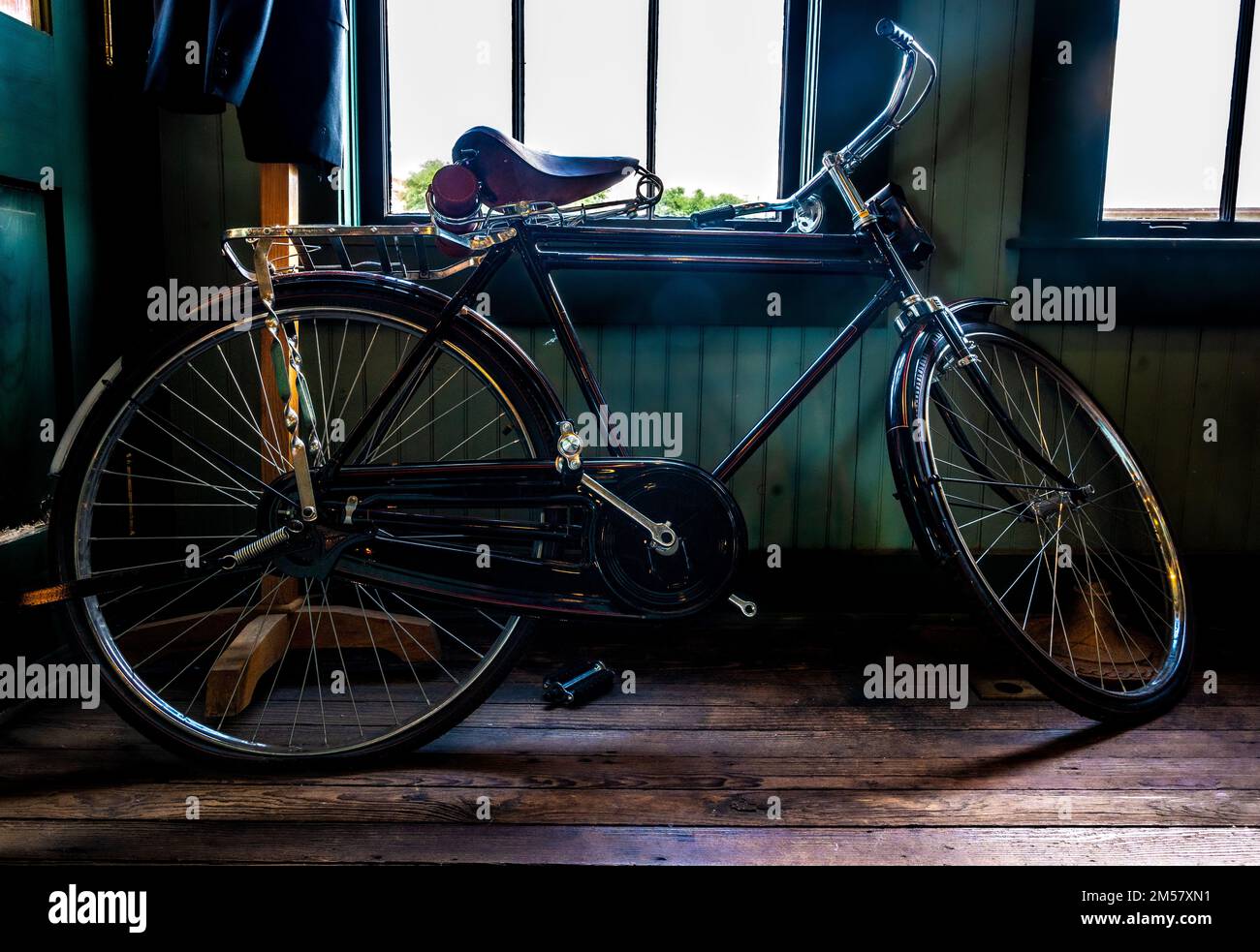 A modern bicycle inside a house with huge wheels on a wooden floor ...