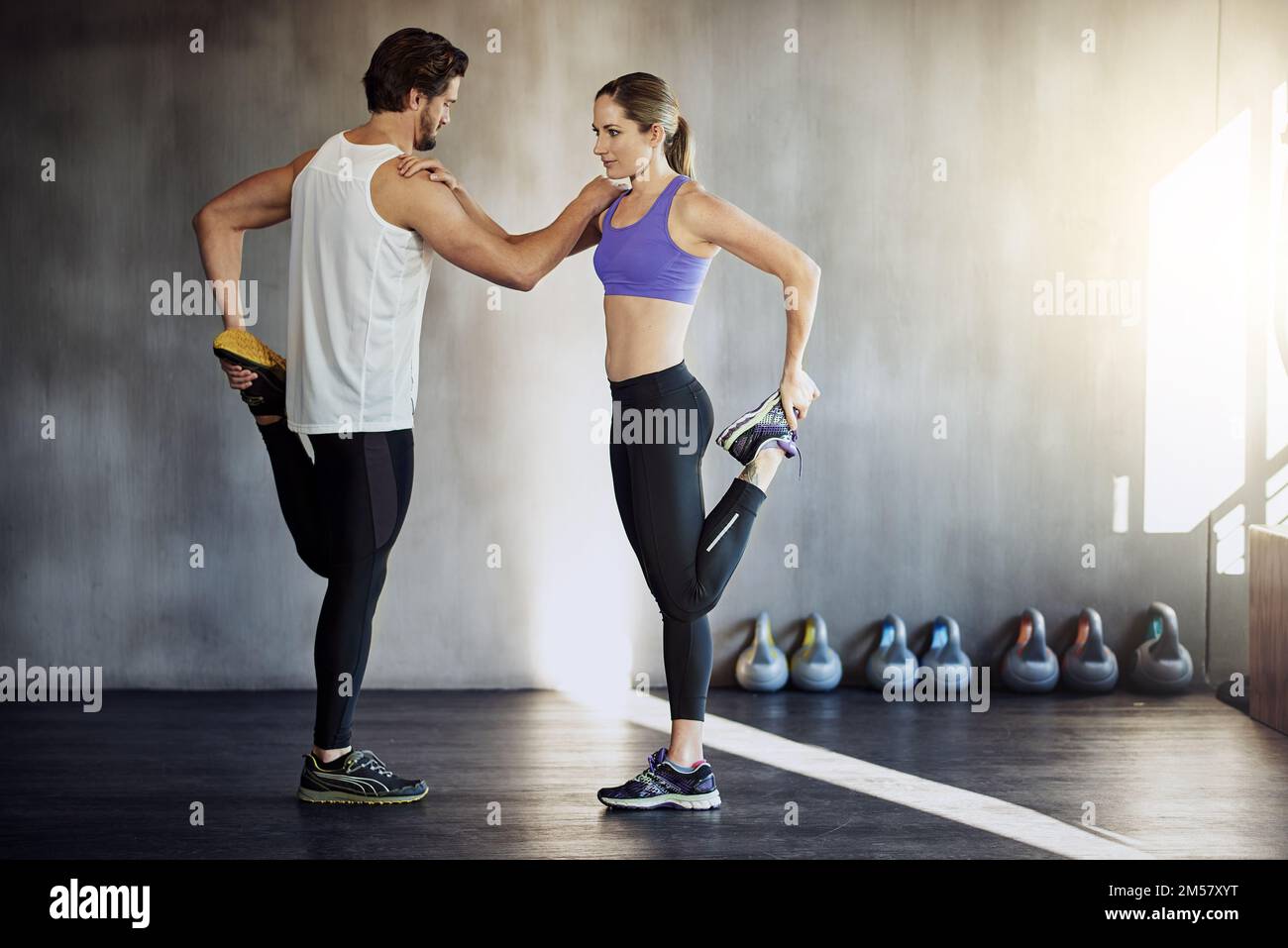 Helping each other stretch. two young people warming up before their workout Stock Photo - Alamy