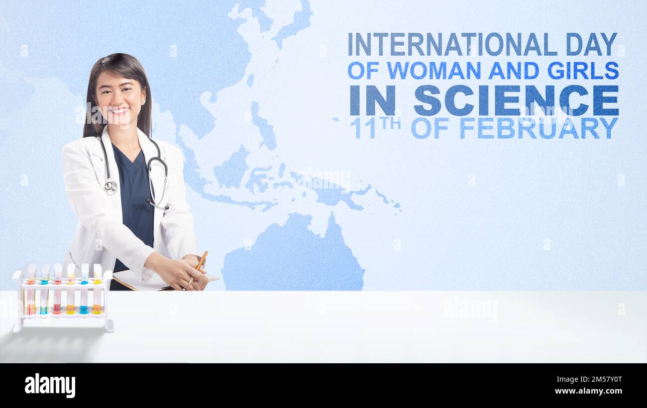 Asian scientists holding a clipboard with International Day of Women ...