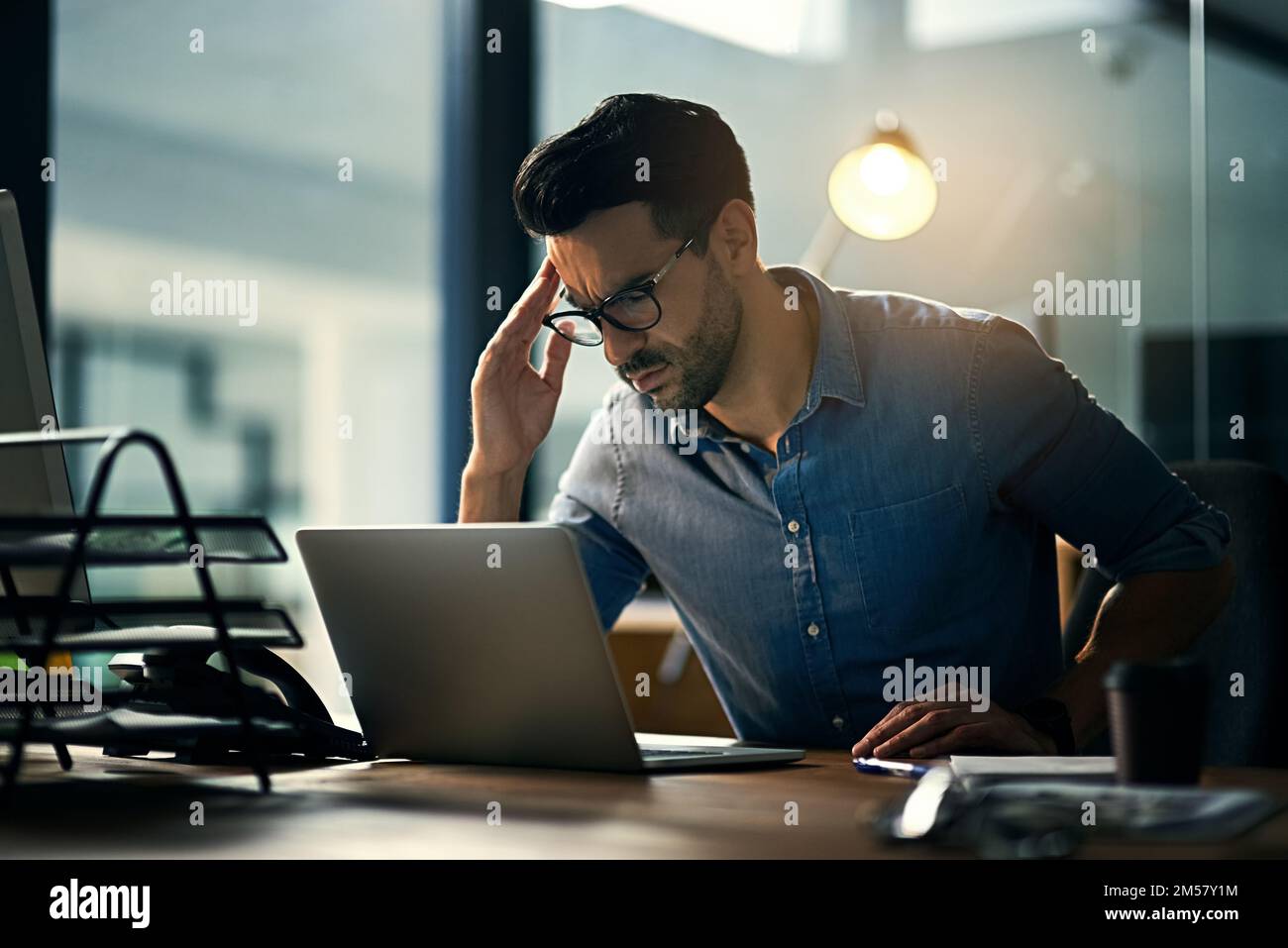 Suffering the consequences of a demanding career. a young businessman ...