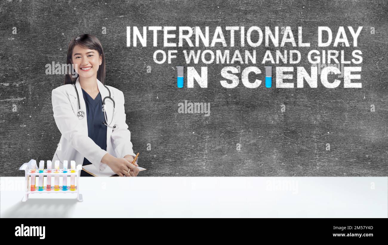 Asian scientists are holding a clipboard with International Day of ...