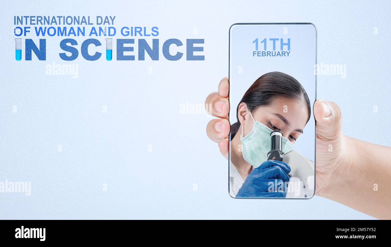 Human hands holding mobile phones with a screen of Asian scientists ...