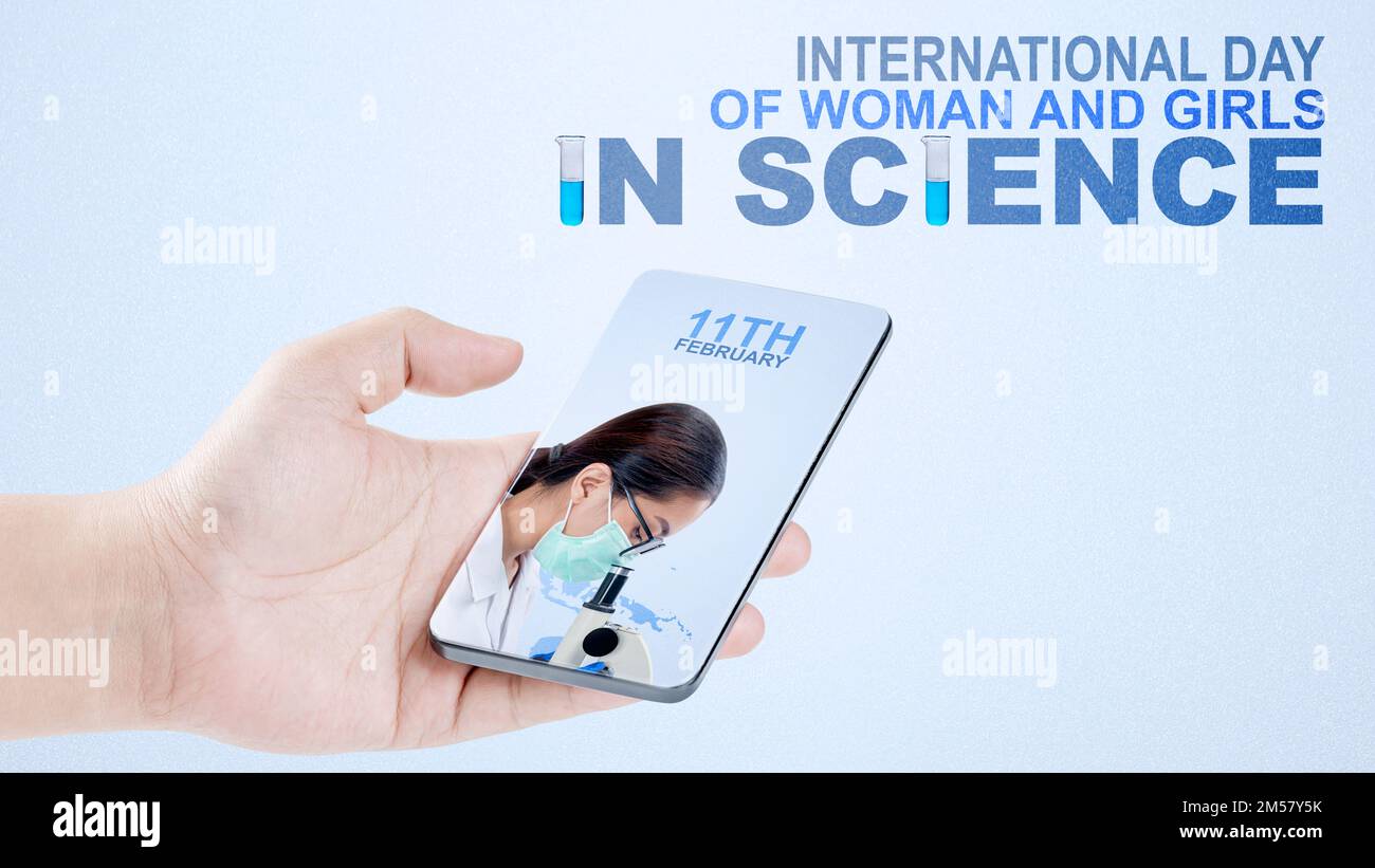 Human hands holding mobile phones with a screen of Asian scientists ...