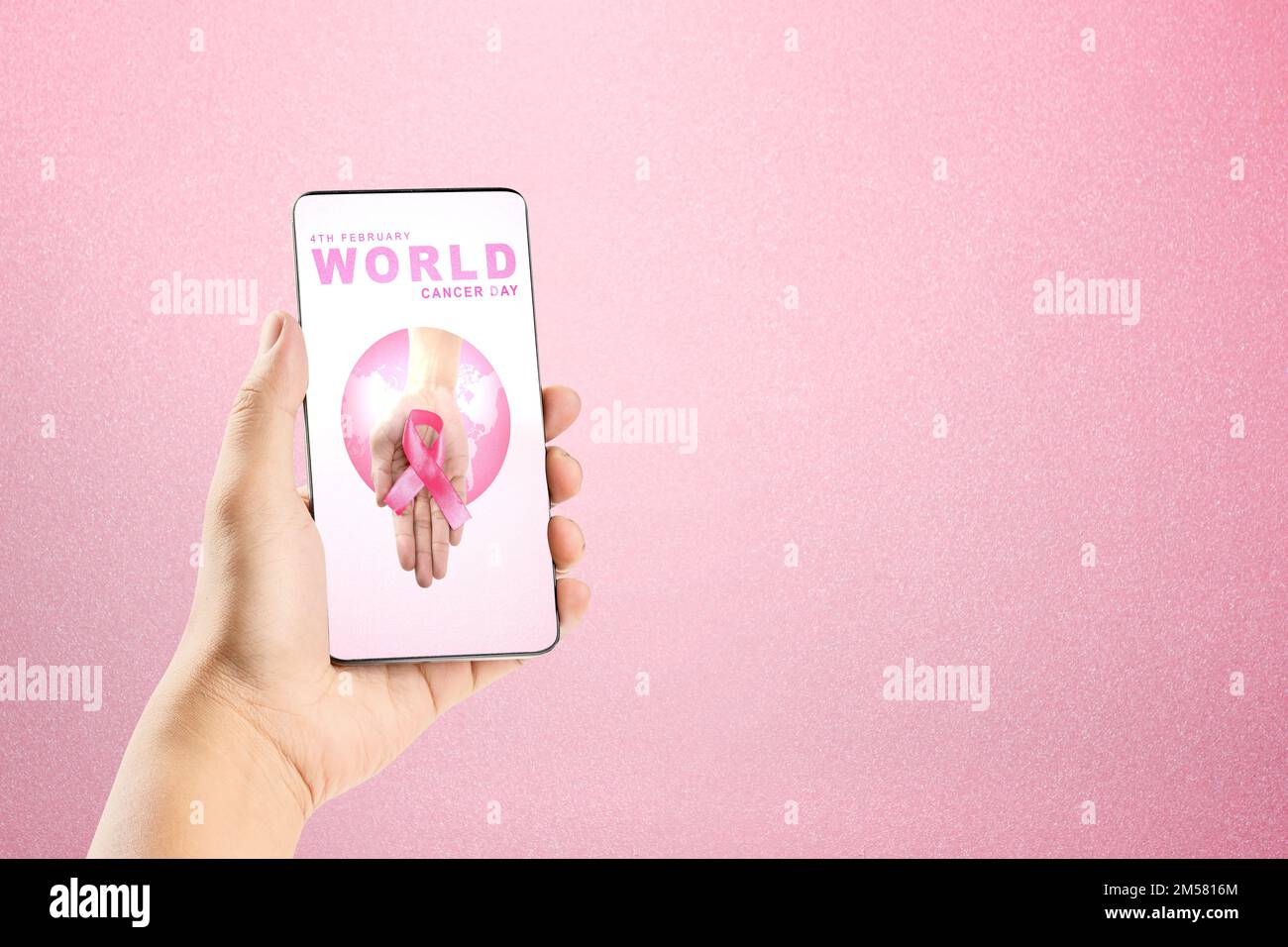 Mobile phone with a screen of a human hand showing purple ribbons ...