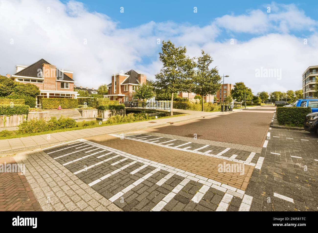 an empty street in the middle of a residential area with white lines ...