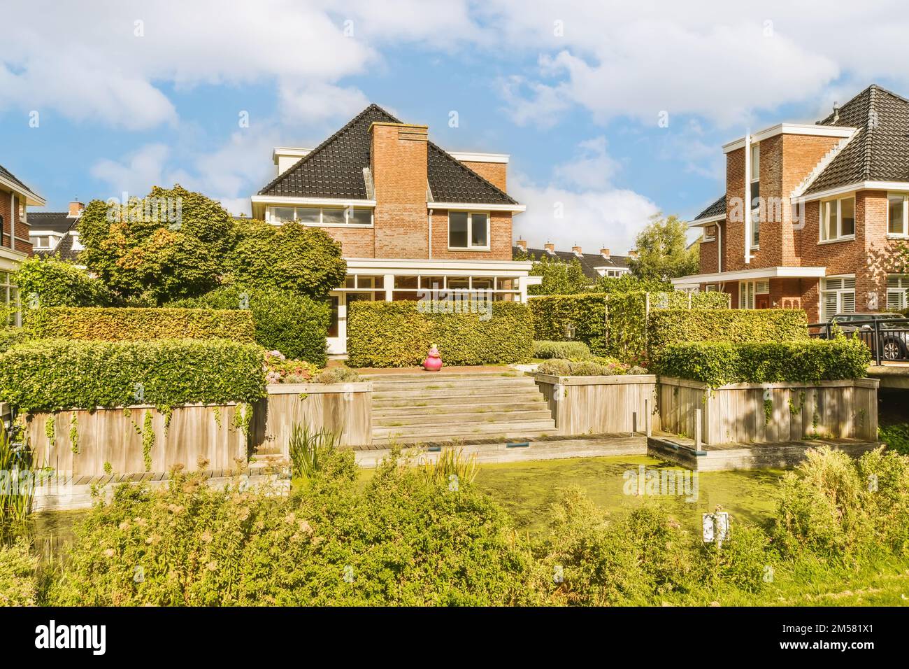 some houses in the middle part of an area with trees, bushes and plants ...
