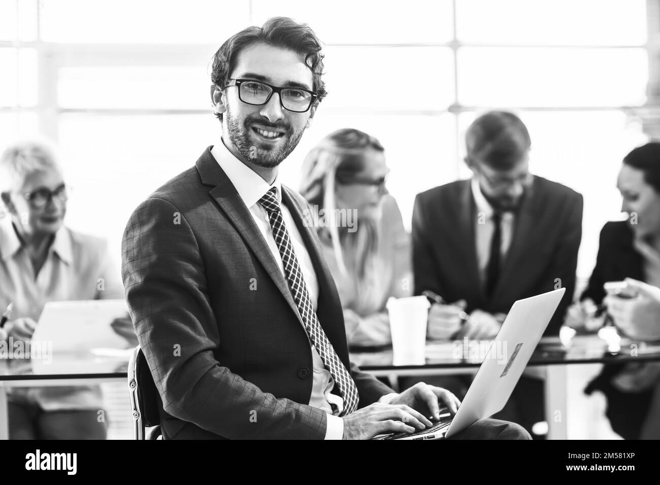 Sitting in office using laptop Black and White Stock Photos & Images ...