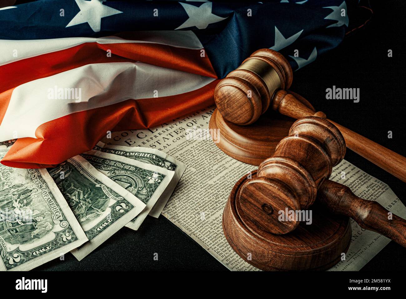 Wooden judge mallet with Dollars notes on the USA flag with Declaration ...