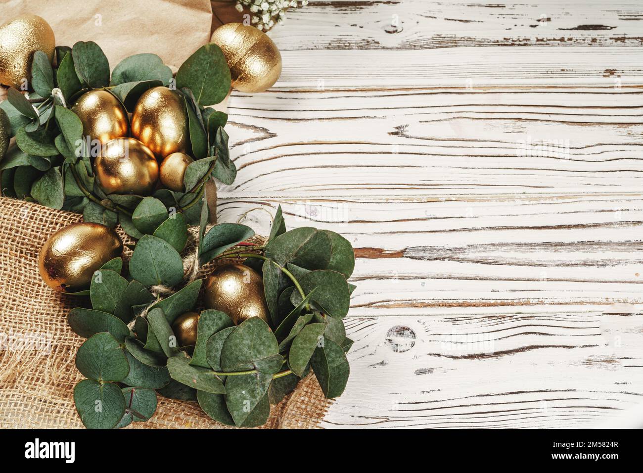 Golden colored eggs for Easter composition with floral branches Stock ...